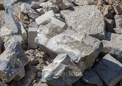 Piles of broken reinforced concrete from a foundation broken out ...
