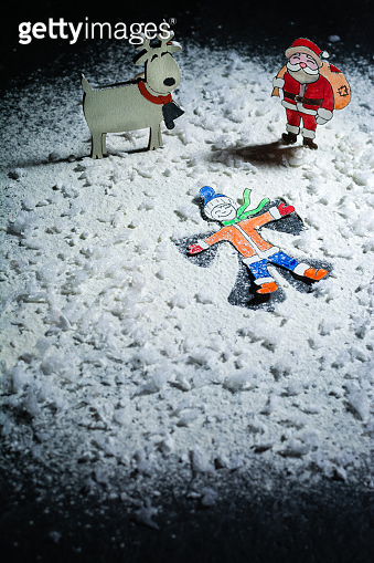 Paper figures of the child as a snow angel Santa Claus and deer. Hand ...