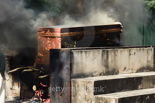 the corpse in the coffin is burning in the cremate, religious ritual ...