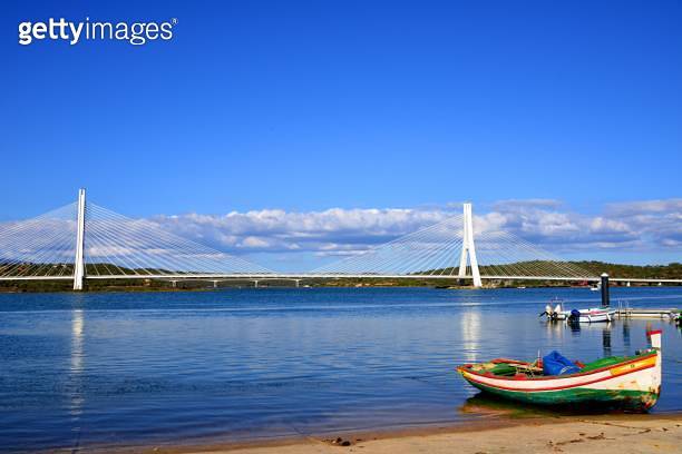 Cable-stayed bridge over the Arade River and fishing boat, Portimão ...