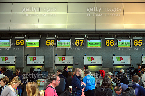 Passengers check-in for TAP Air Portugal flights at Lisbon Airport ...