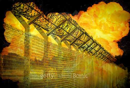 Realistic orange fire explosion behind restricted area barbed wire ...