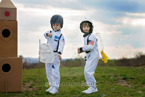 Two adorable children, boy brothers, playing in park on sunset, dressed ...