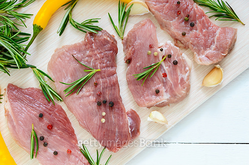Raw flat meat for steak (chop) with spices on a light background. 이미지 ...