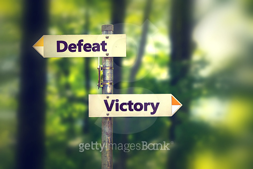 Signpost in a park with arrows pointing in two opposite directions ...