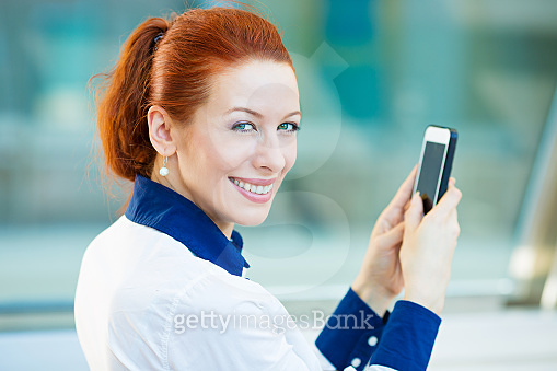 happy, cheerful, excited girl, using cell phone, taking picture ...