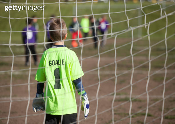 Soccer Goalie Standing in Front of Net with Players in Background 이미지 ...