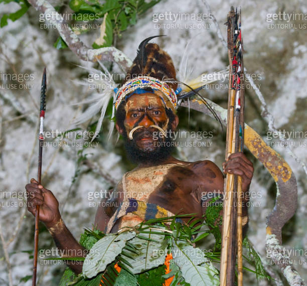 Warriors tribe Yaffi in war paint with bows and arrows in the cave. New ...