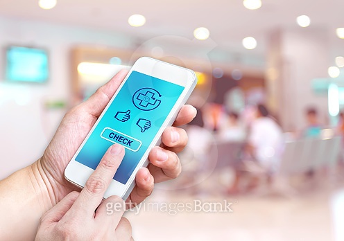 Hand holding mobile with Health check button and thumb up good or bad ...