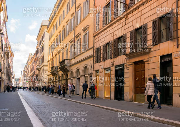 people walking along the luxury shopping avenue Via del Babuino in Rome ...