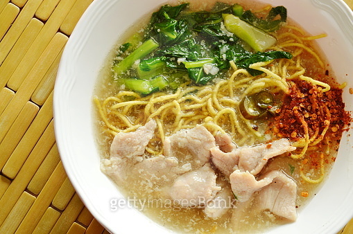 crispy fried yellow noodle with marinated pork and kale in gravy sauce ...