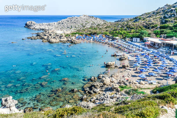 Beachgoers enjoy famous Anthony Quinn Bay beach in Rhodes, Greece 이미지 ...