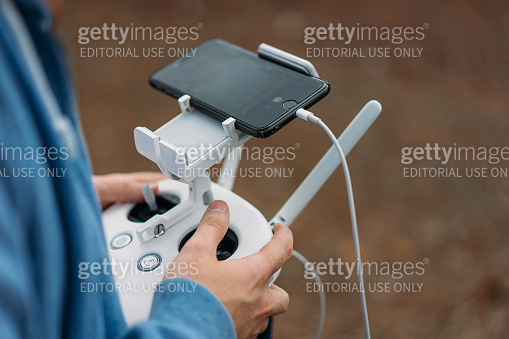 Young man operating a drone remote control console 이미지 (860804020) - 게티 ...
