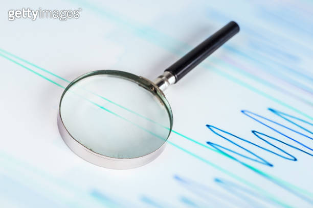 DNA sequencing peaks show on tablet with magnifier glass (866871416 ...