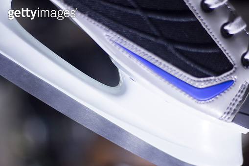 Ice skates in skate store shop window on display on sale for skating on ...