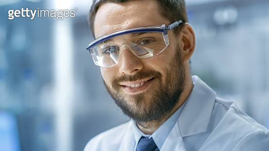 Close-up Shot of Scientist Face Looking and Smiling into Camera in a ...