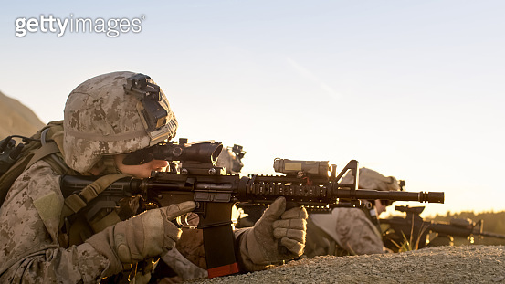 Side view on Soldiers Lie Down on the Hill, Aiming through the Assault ...