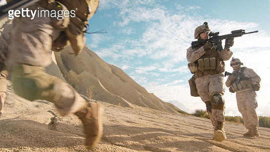 Squad of Fully Equipped and Armed Soldiers Running and Aiming in Single ...