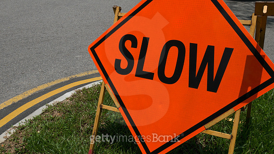 Slow down red banner traffic sign on the road. (671590236) - 게티이미지뱅크