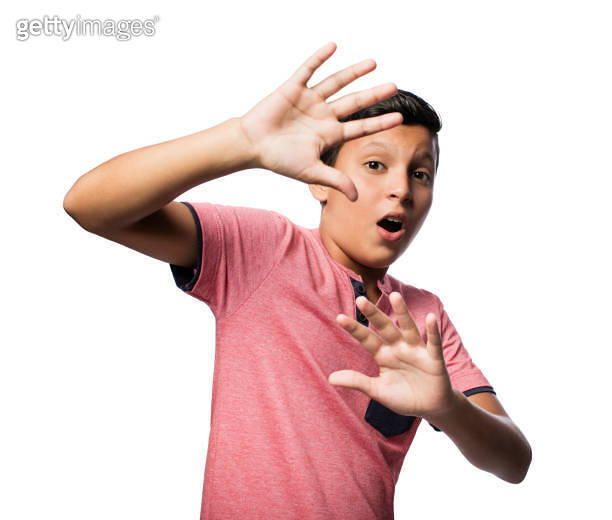Scared teenage boy raising his hands in front 이미지 (813380562) - 게티이미지뱅크
