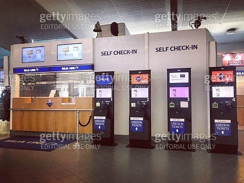Self-check-in machines and tickets counters inside Silja Line Ferry ...