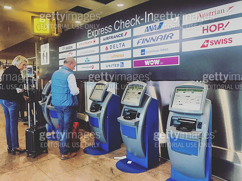 People using self check-in machines inside Brussels Airport, Belgium ...
