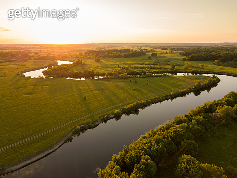 Top view of the Seim River (Ukraine), surrounded by trees and meadows ...