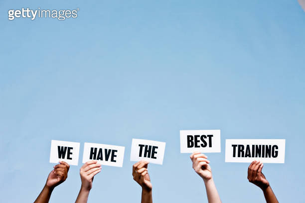 Hand-held signs read "We have the Best Training" against blue 이미지 ...