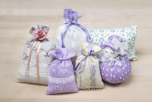 Bunch of different scented sachets for decoration on wooden board. Many ...