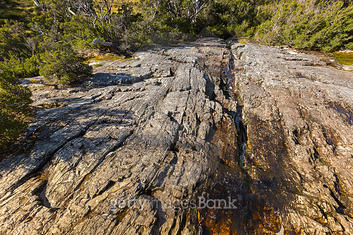 Natural stream of water running through volcanic basalt rock at Lake ...