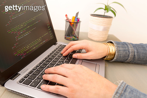 Programming Work Time. Programmer Typing New Lines of HTML Code. Laptop and Hand Closeup ...