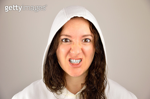 snarling woman wearing hoodie 이미지 (816923860) - 게티이미지뱅크