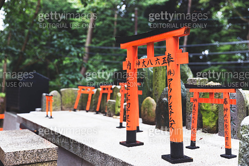 Small Torii gates with Japanese inscriptions at the Fushimi Inari ...