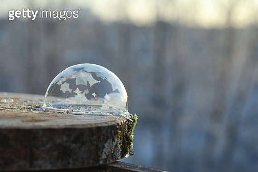 Soap bubbles freeze in the cold. Winter soapy water freezes in t ...