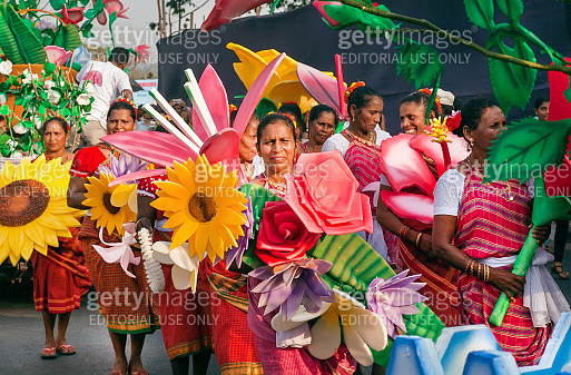 Happy women in crowd of people at the bright parade of traditional Goa ...
