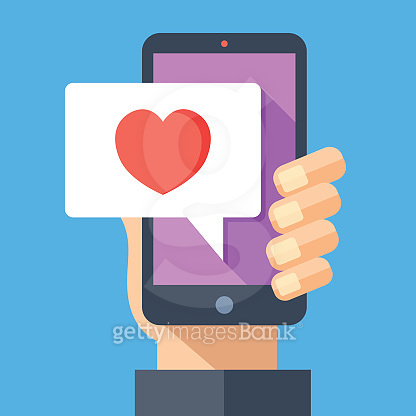 Hand holding smartphone with heart emoji message on screen, like button ...