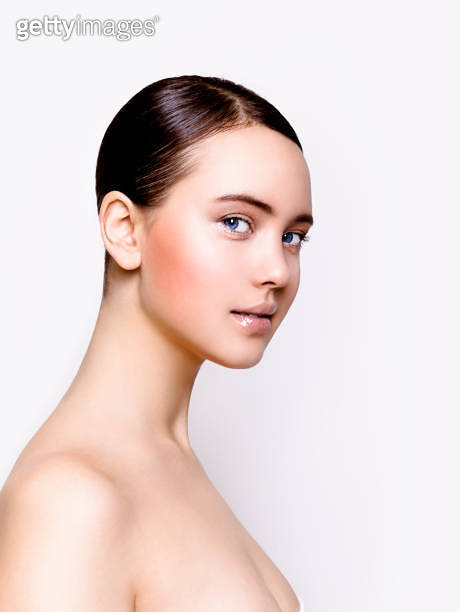 Young woman with glowing skin and natural make-up Looks perfect Close ...