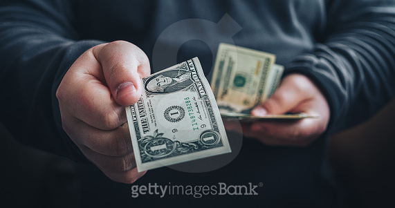 Man giving one us dollar banknote and holding cash in hands. Toned ...