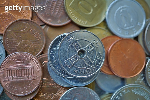 Macro detail of five Norwegian Crowns (NOK) on the top of heap made of ...