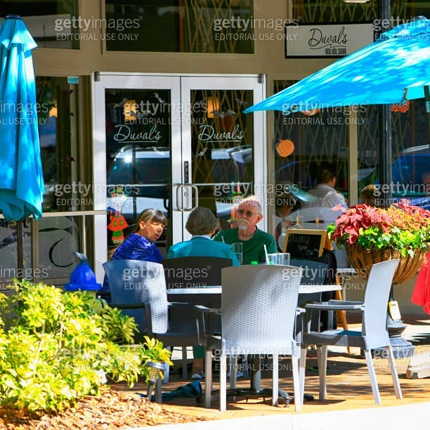 People sitting outside a restaurant enjoying lunch in downtown Sarasota ...