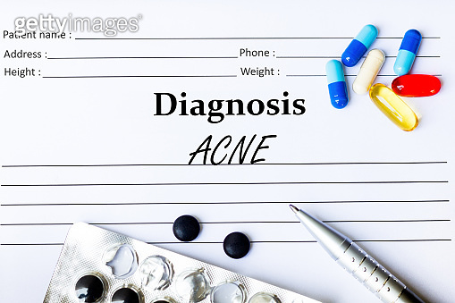 Acne - Diagnosis written on a piece of white paper with medication and ...