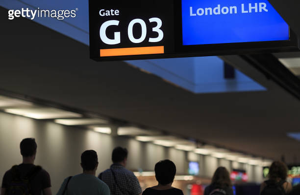Airport interior with passenger silhouettes, gate number three board ...