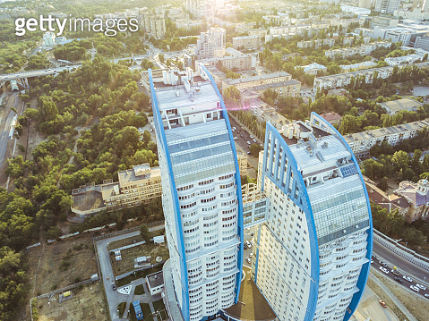 aerial view of two identical tall high buildings with bridge between ...