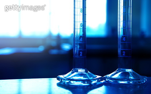 two glass measuring cylinders in chemical science technology laboratory ...