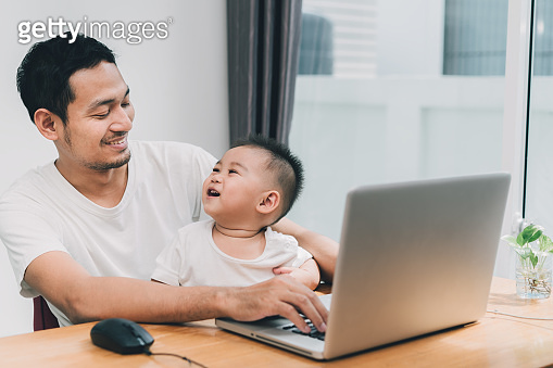 father and little son happy family concept, Dad work typing something ...