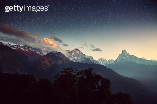 Night landscape on early morning. Starry sky with over the mountains ...