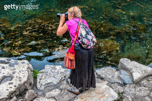 Woman photographer photographing in Black Tiger Spring Park and Jinan ...