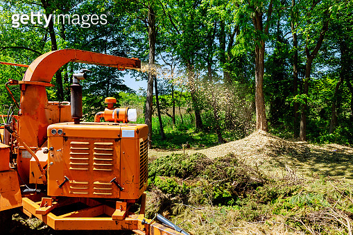 Wood Chipper in Action captures a wood chipper or mulcher shooting ...