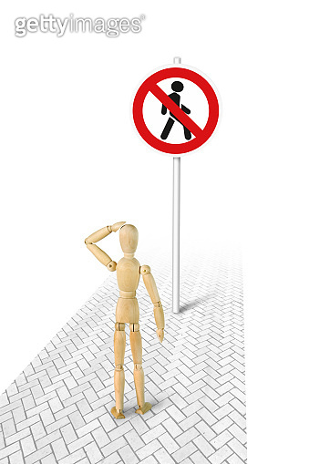 Man in confusion standing in front of No Pedestrian Traffic road sign ...