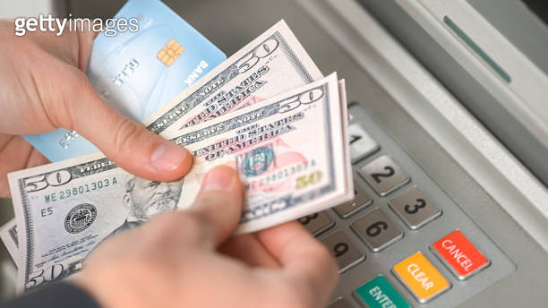 Man taking money out of cash dispenser at ATM, counting it (913326868 ...